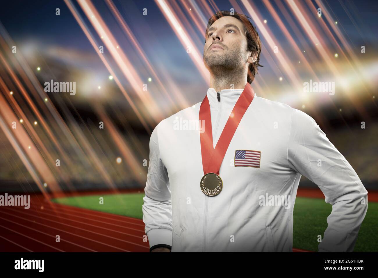 American male athlete smiling after winning a gold medal in a stadium ...