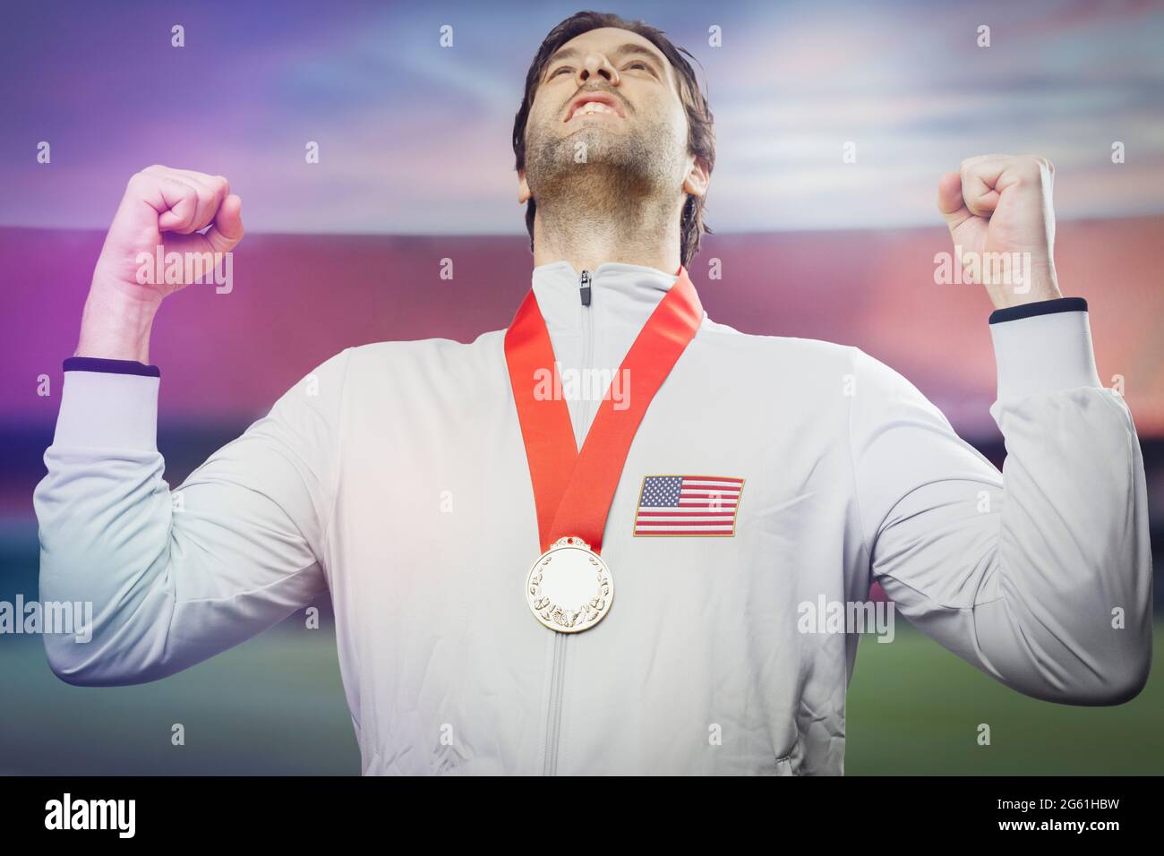 American male athlete smiling after winning a gold medal in a stadium ...