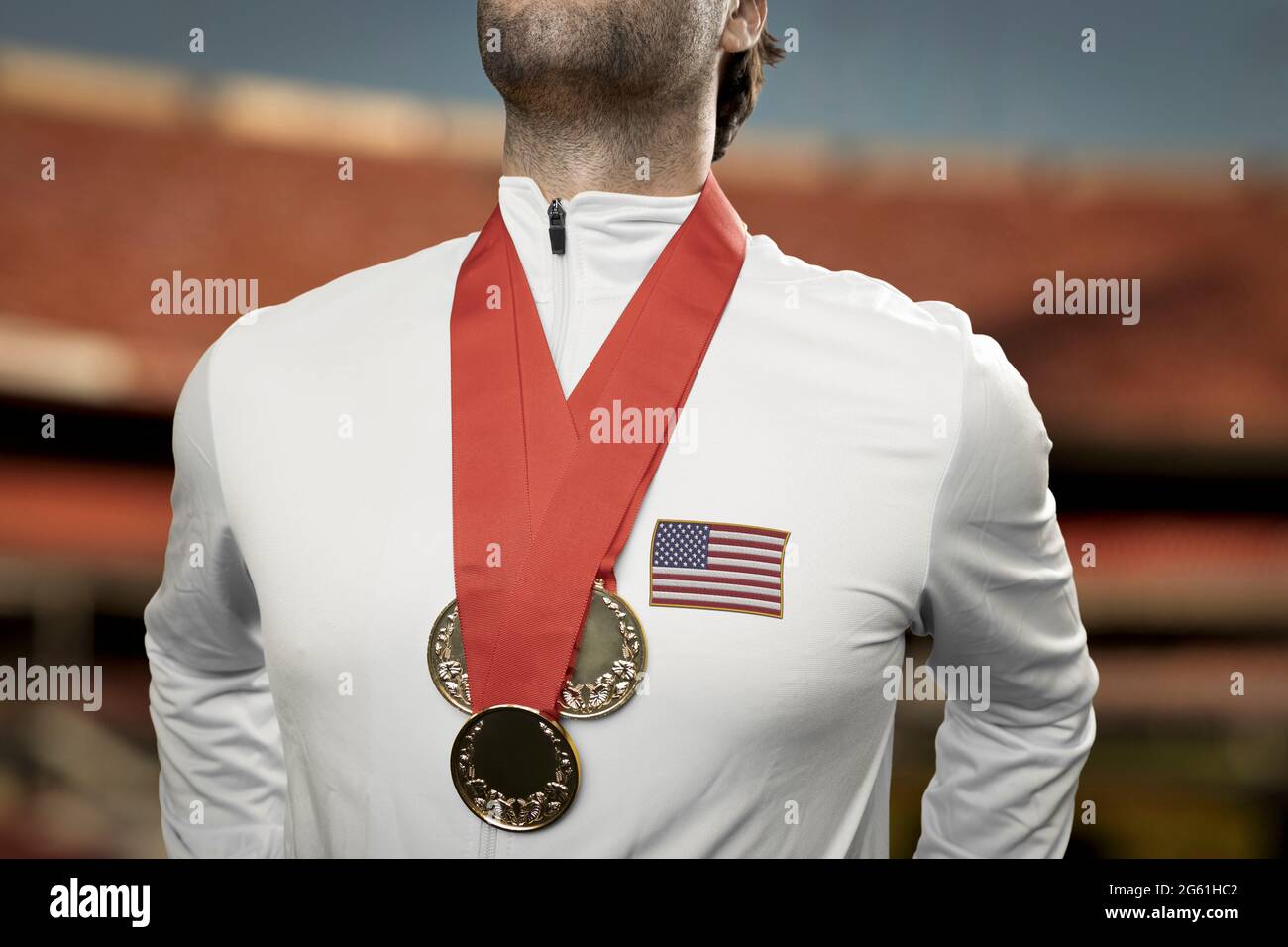 American male athlete smiling after winning a gold medal in a stadium ...