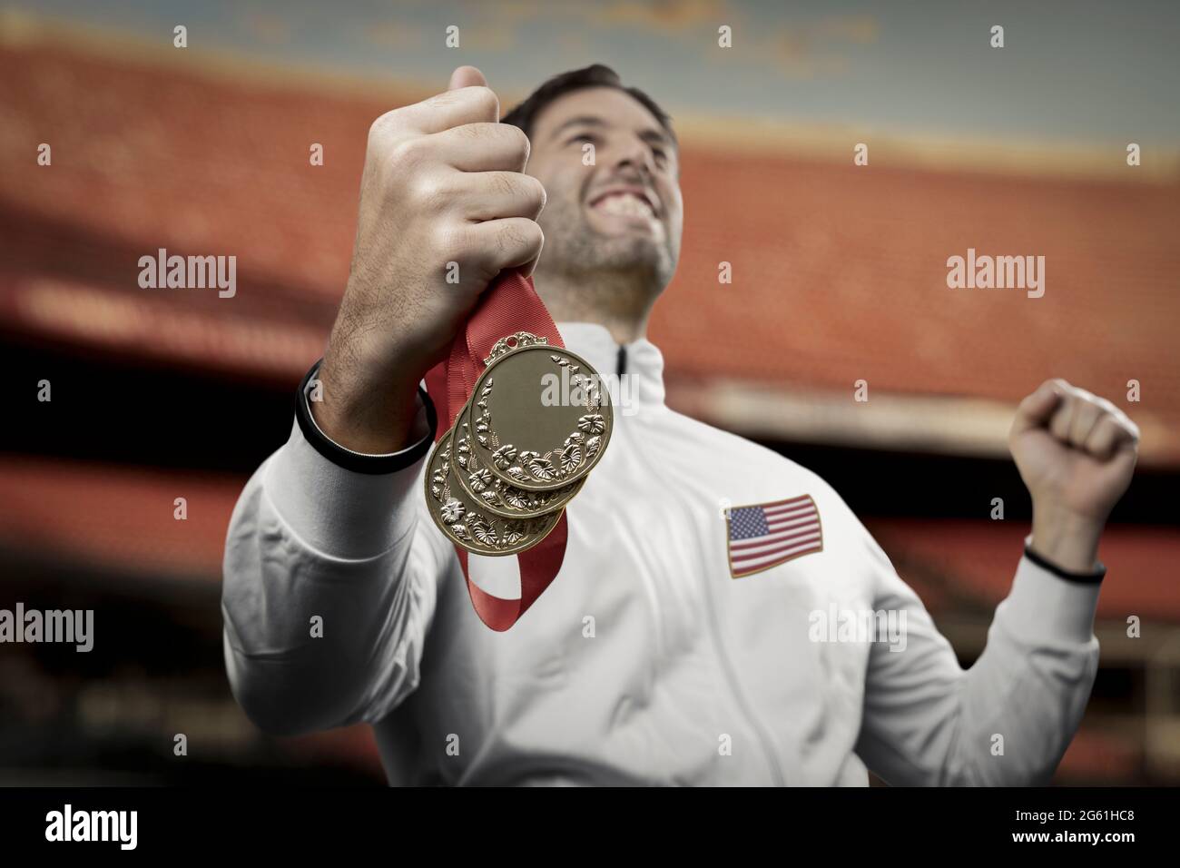 American male athlete smiling after winning a gold medal in a stadium ...