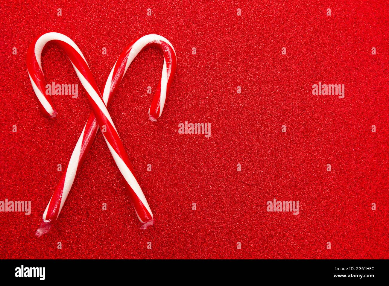 Red and White Stripped Traditional Candy Canes on a Glitter Background ...