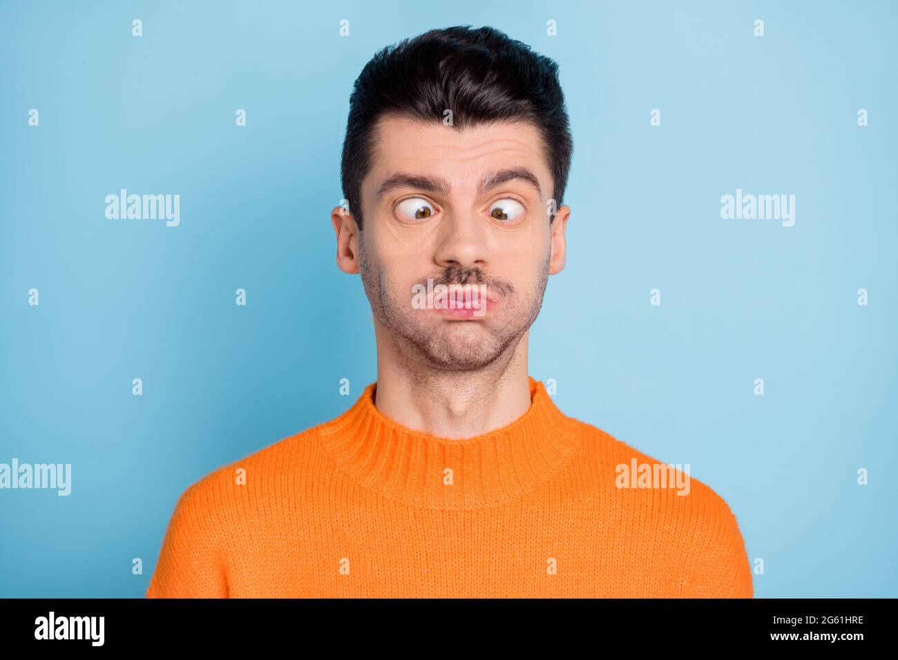 Photo of young man comic crazy dumb fooling childish hold breath ...