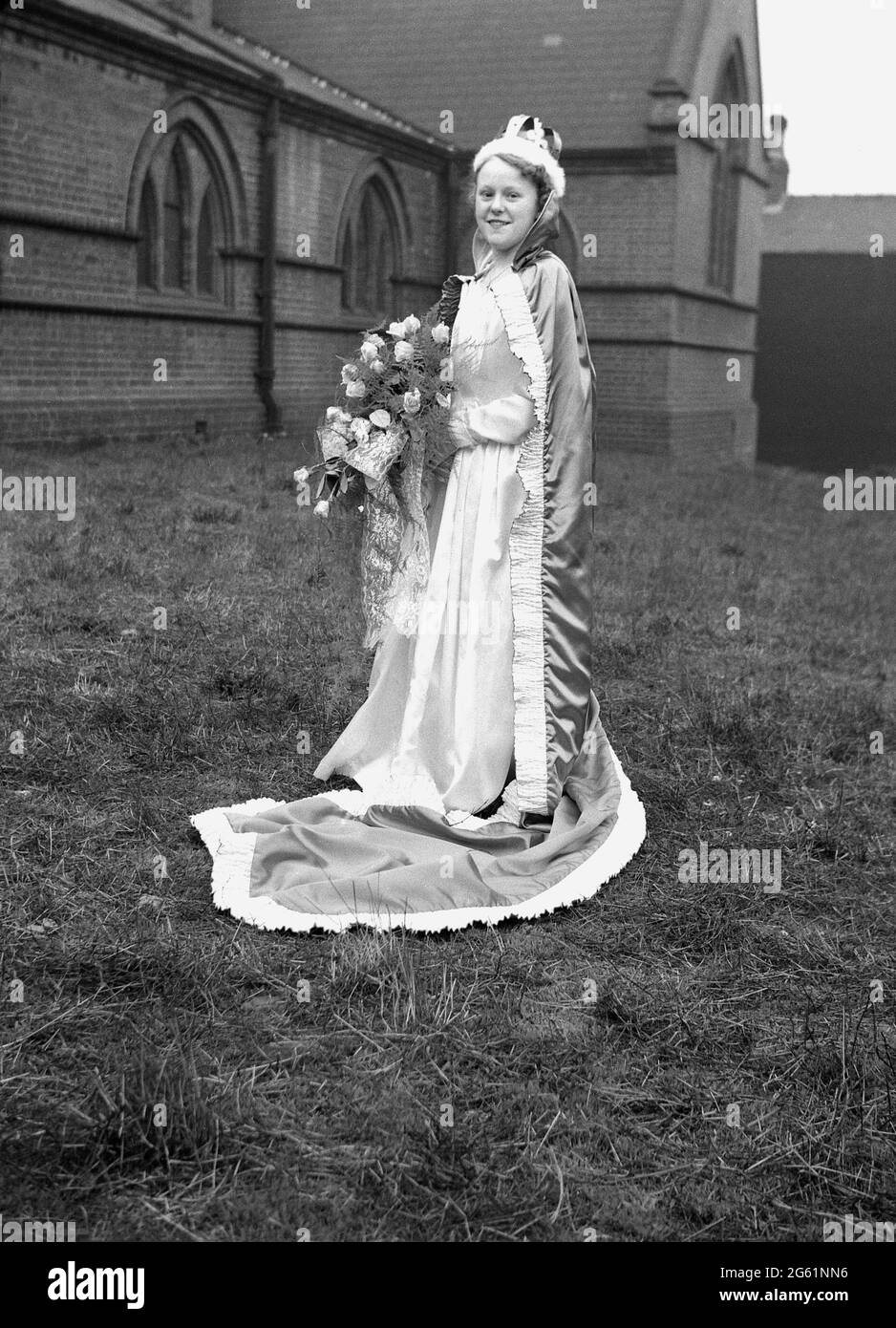 1956, historical, outside in the grounds of a church, a May Queen ...