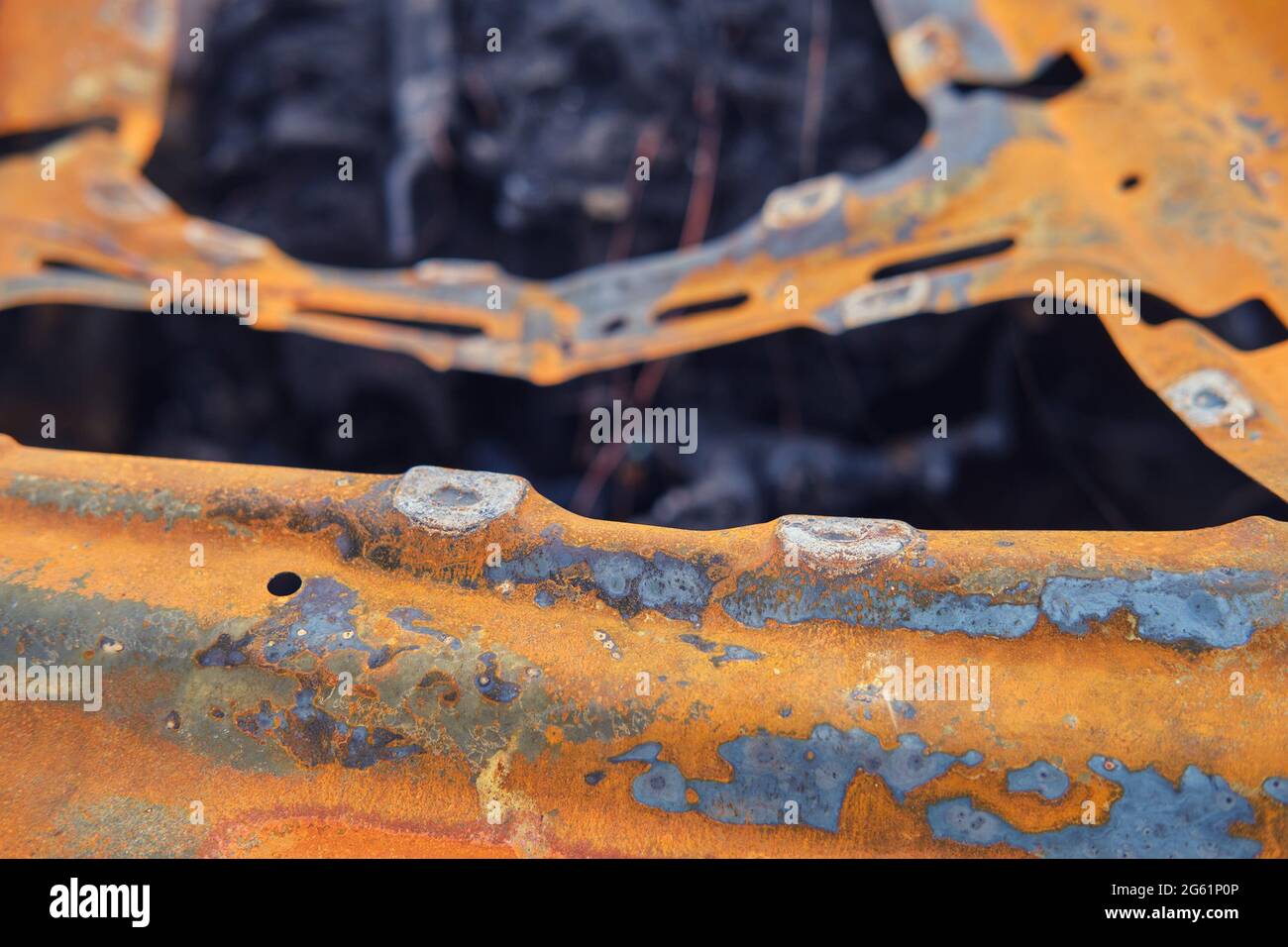 Burnt-out rusty cars on a city street, vandalism. Setting fire to cars ...