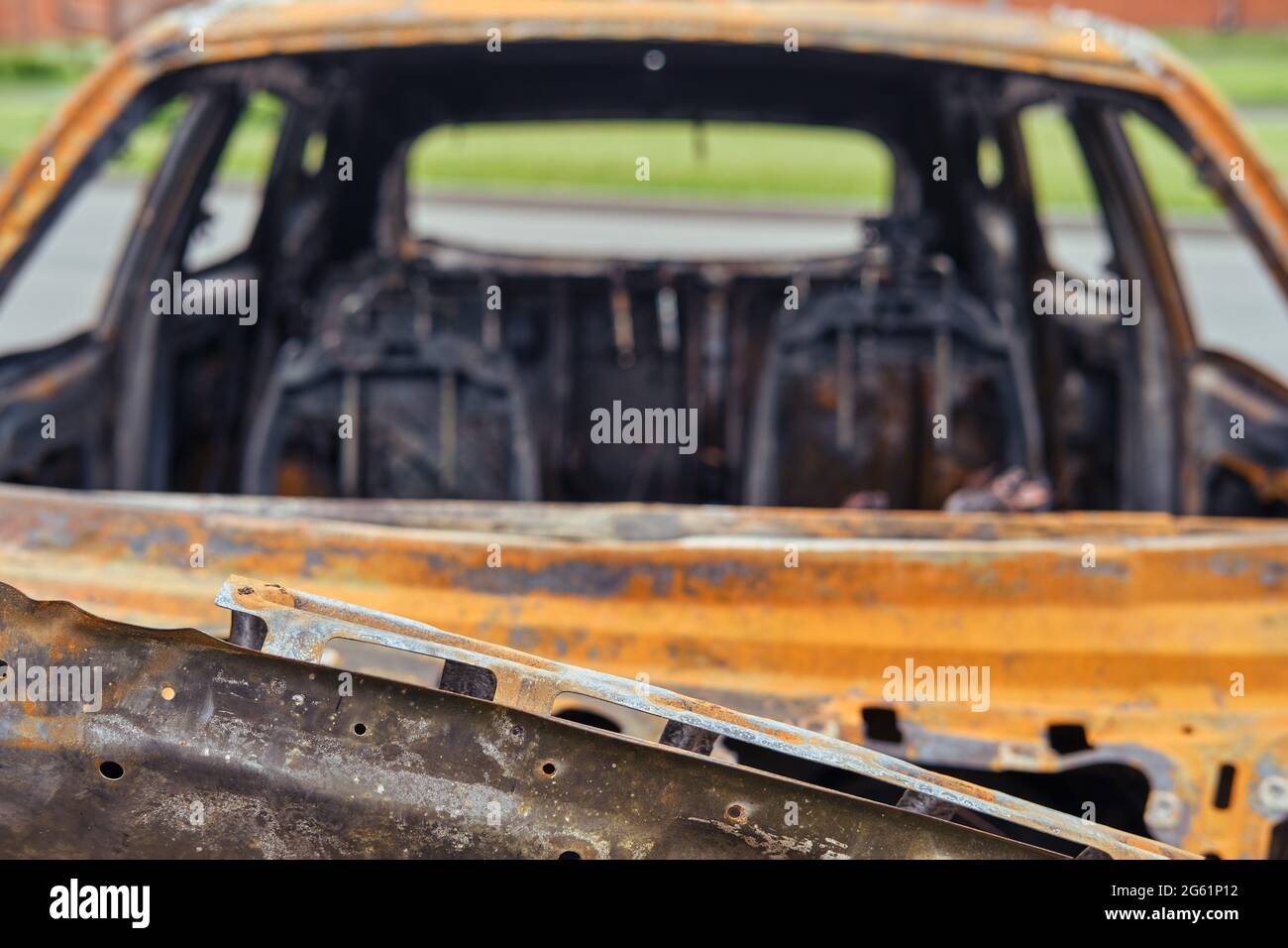 Burnt-out rusty cars on a city street, vandalism. Setting fire to cars ...