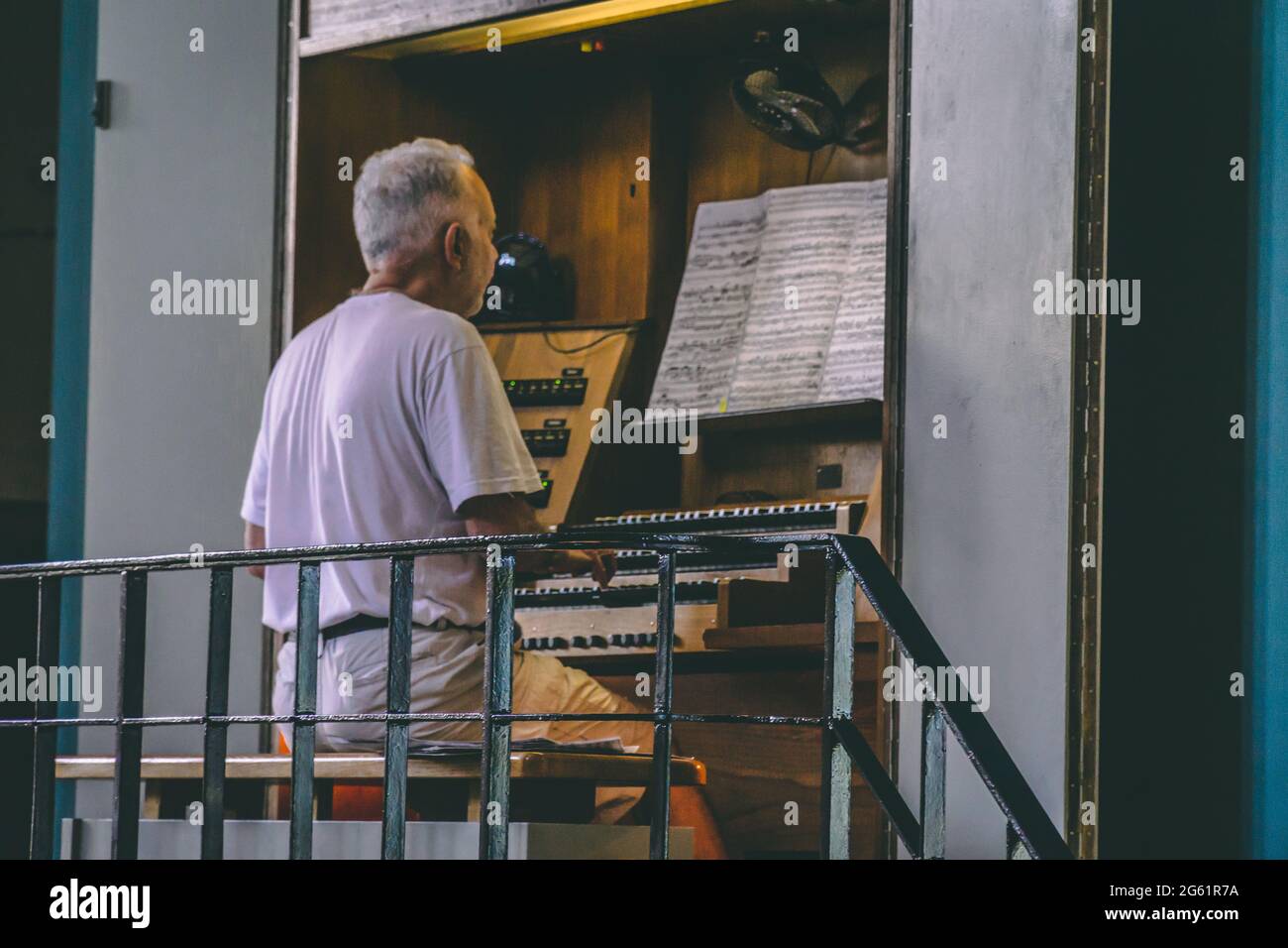 An old man sits in front of the notes and plays the organ Stock Photo ...