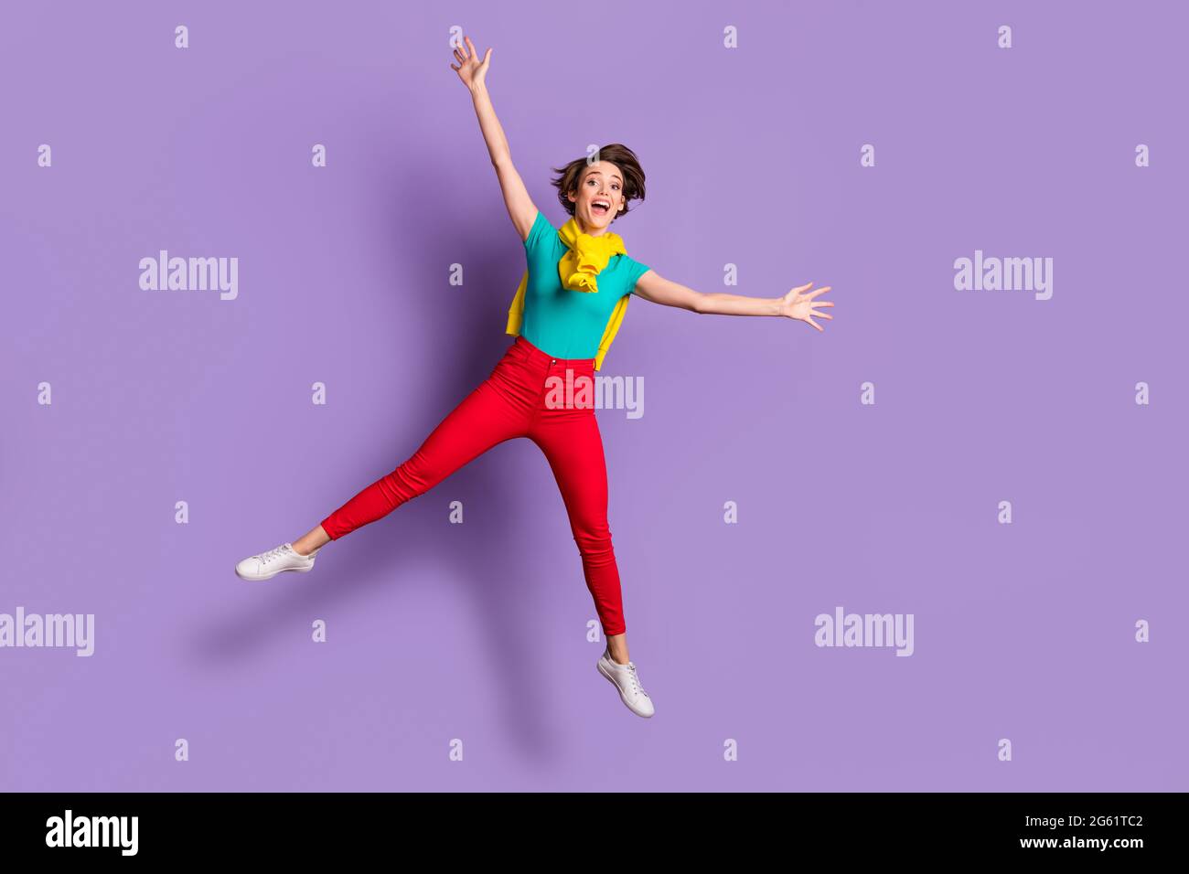 Full length photo of girl jump raise hands wear knotted pullover t ...