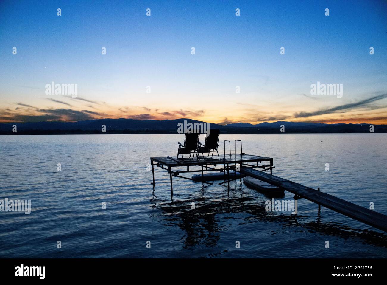 Lake Sunset Dock Fishing View Hills Sky Clouds Stock Photo - Alamy