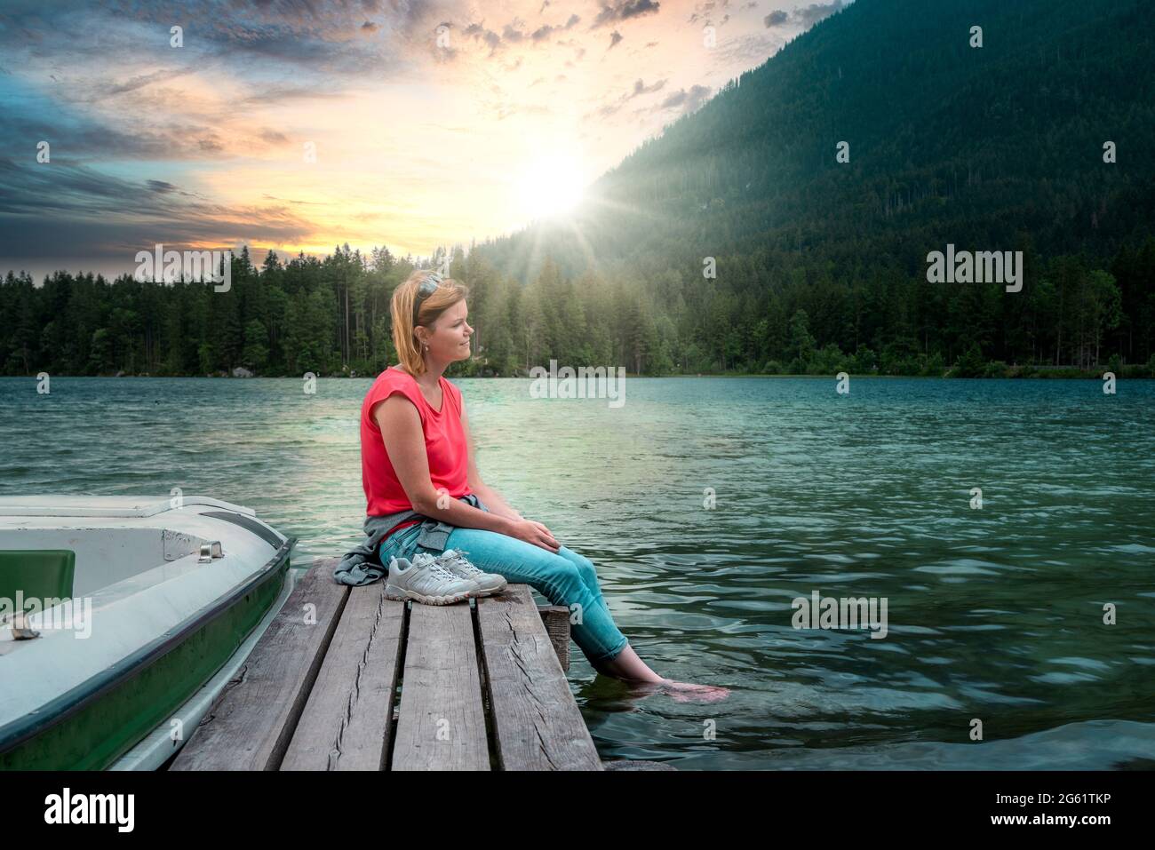 Young woman relaxing on pier at the lakeside Stock Photo - Alamy
