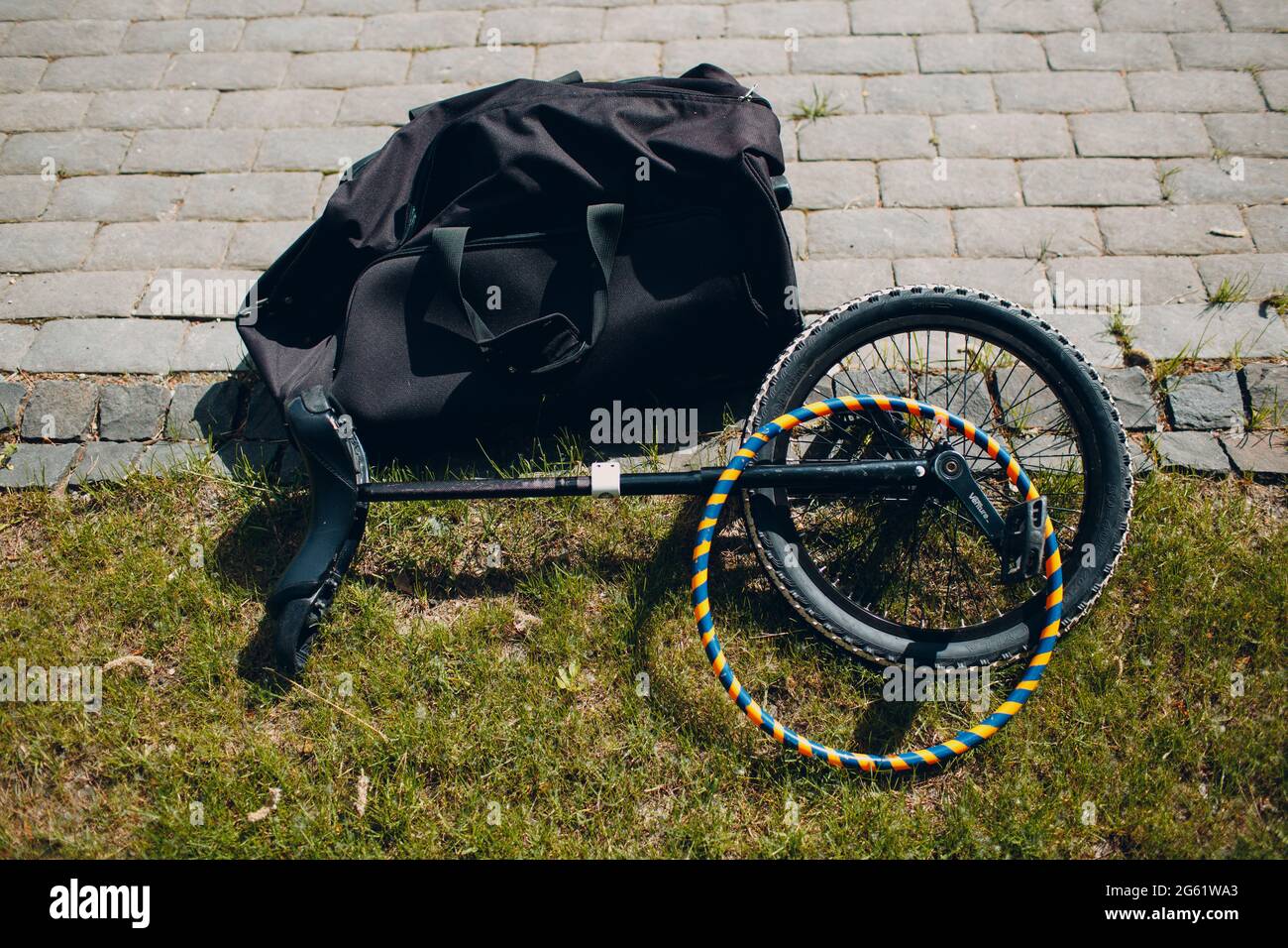 Circus unicycle laying on a green grass Stock Photo - Alamy