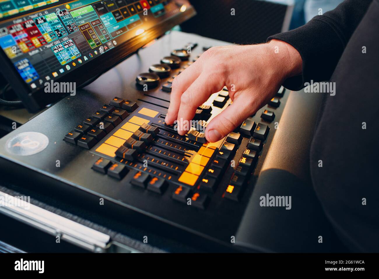 the sound engineer hand moves the sliders on the sound mixing console ...