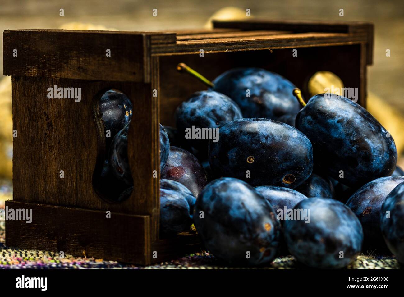 Ripe blue plums in a wooden crate in a rustic composition Stock Photo ...