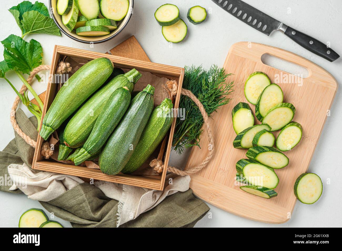 Slicing zucchini on a cutting board. Ripe zucchini on a gray background ...