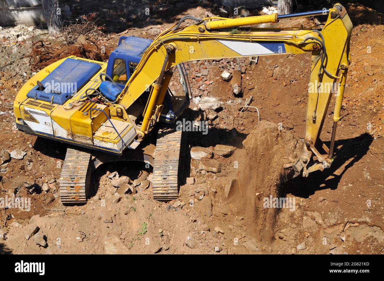 Excavator continues to work at the construction site, excavation site ...