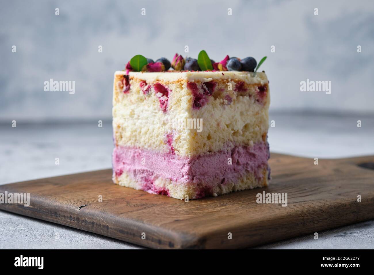 A cutaway berry sponge cake. Cake with cream cheese mousse, condensed ...