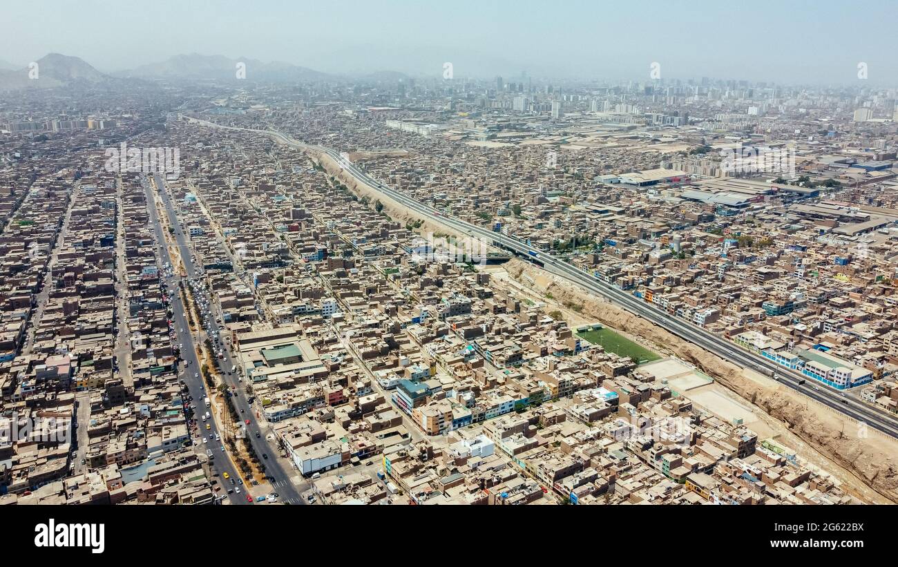 Aerial view of the district of San Martin de Porres and the Rimac river ...