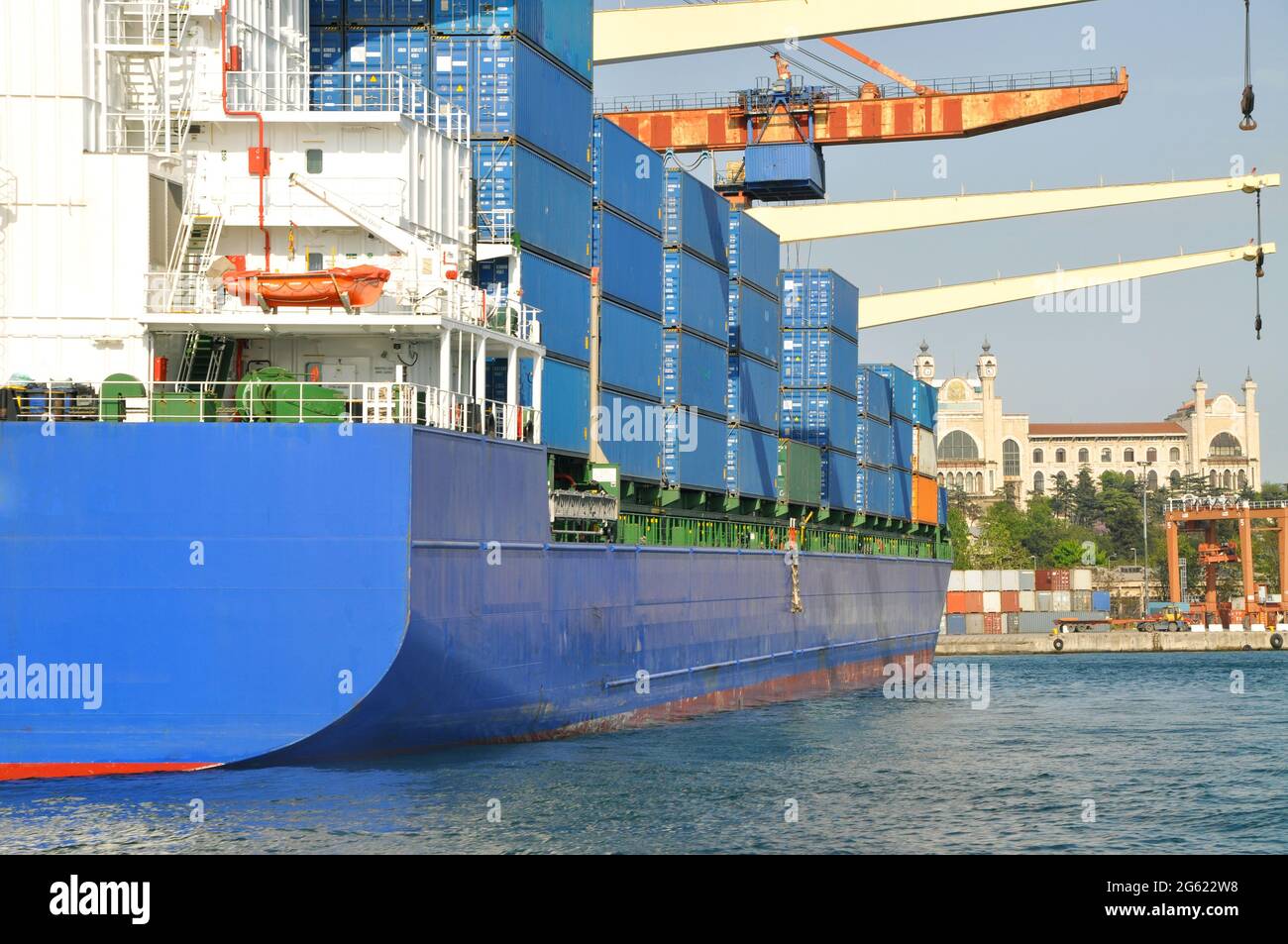 Blue colored cargo ship engaged in international logistics ...