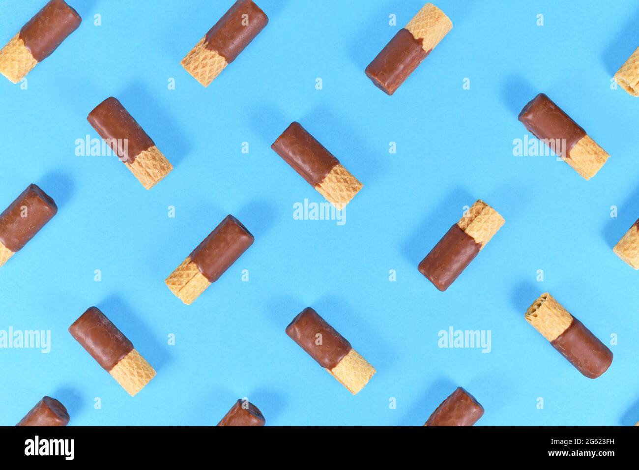 Chocolate glazed waver rolls sweets arranged on blue background Stock ...