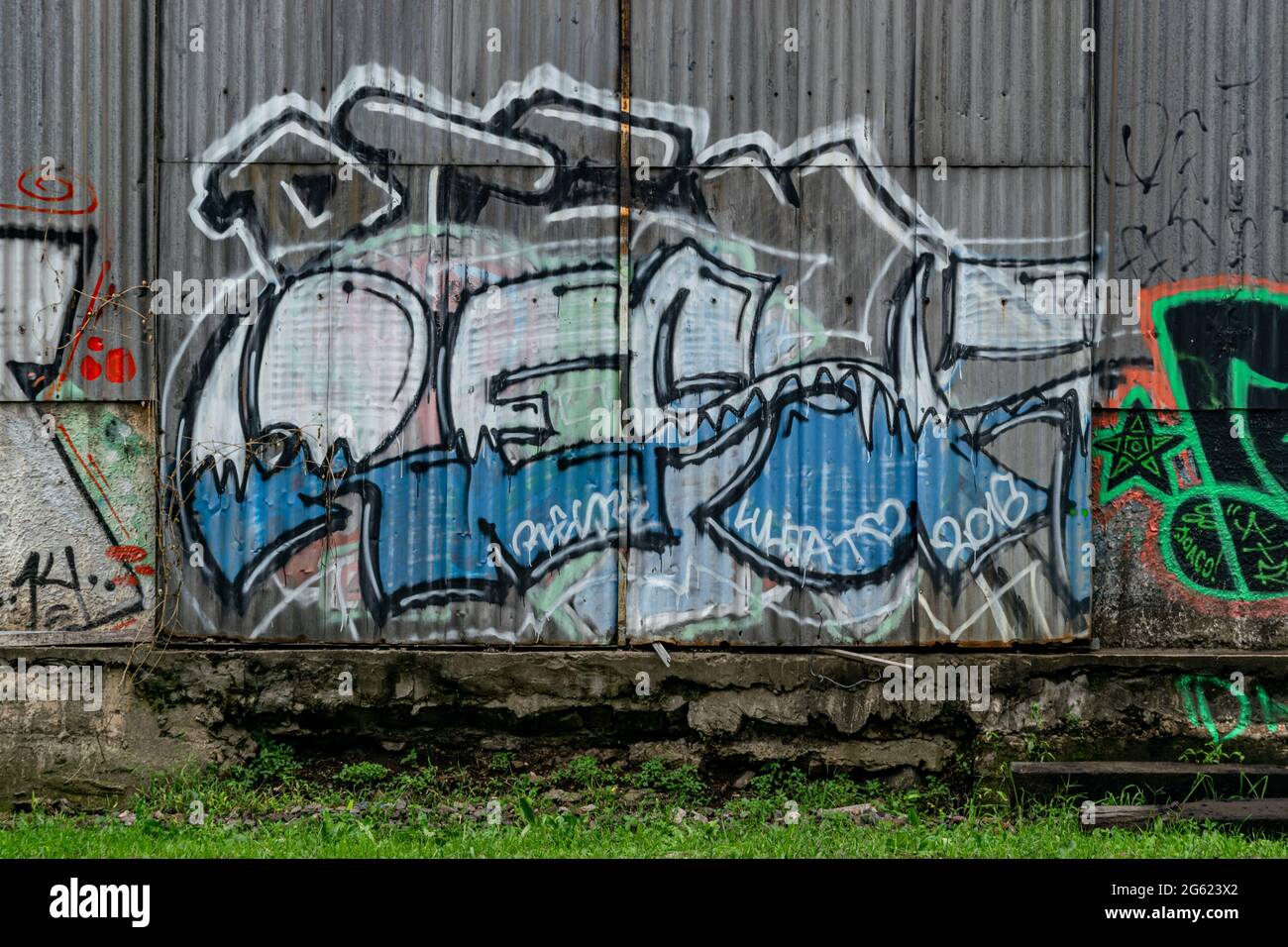 Graffiti painted on metal sheds in the railroad yard in Colegiales ...