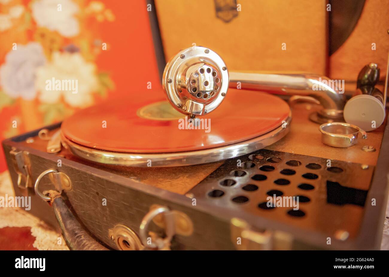 Closeup shot of a vintage gramophone with a vinyl disc on a blurred ...