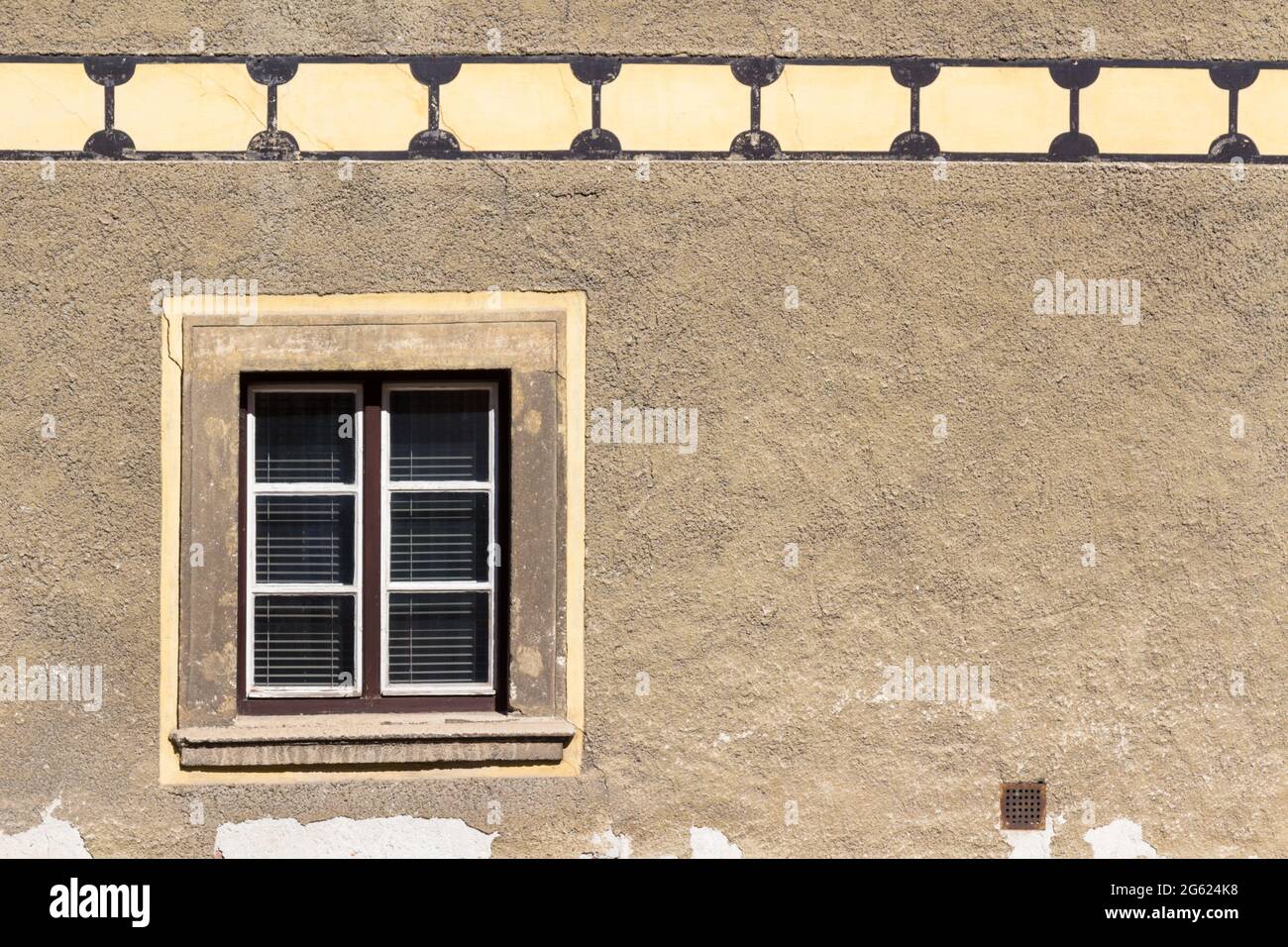 Detail of Medieval house front, stone frame window and painted pattern ...