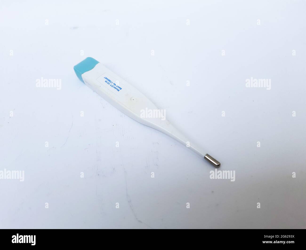 White digital thermometer on a white surface Stock Photo - Alamy