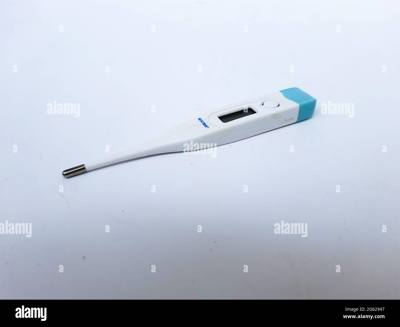 White digital thermometer on a white surface Stock Photo - Alamy