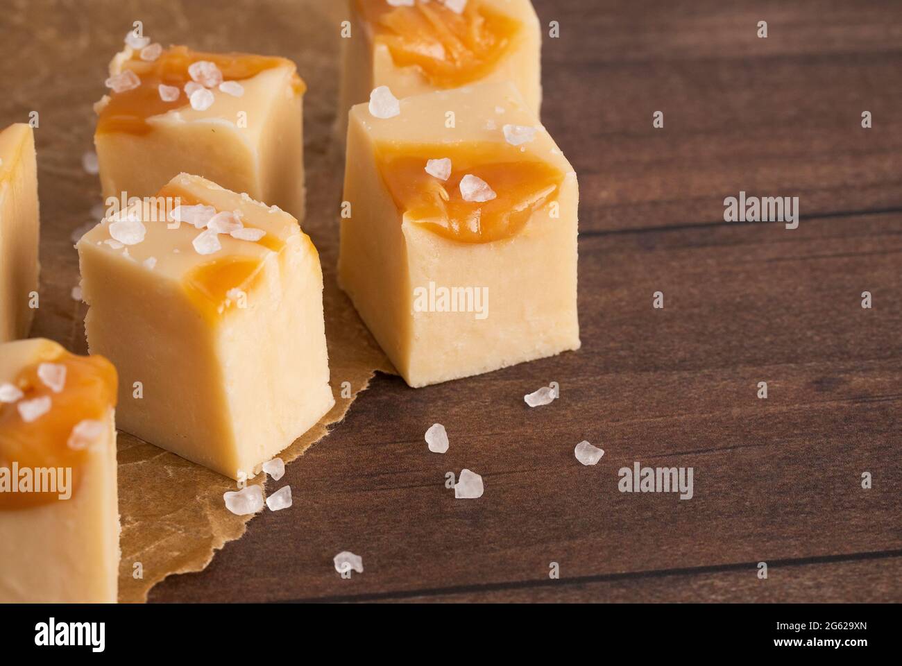 Sea Salt and Caramel Fudge on a Wooden Table with Baking Paper Stock ...