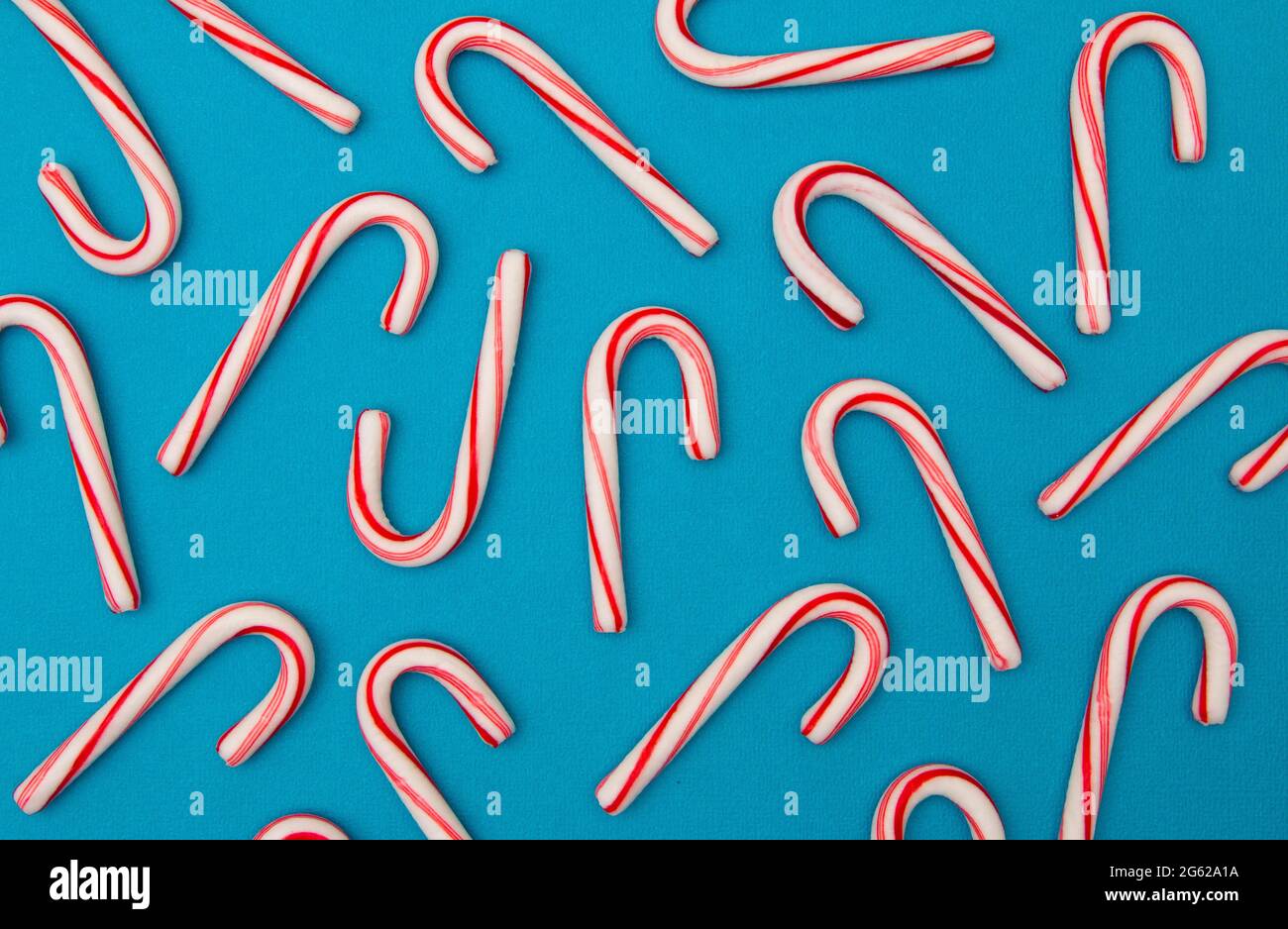 A Candy Cane Background on a Blue Background Stock Photo - Alamy