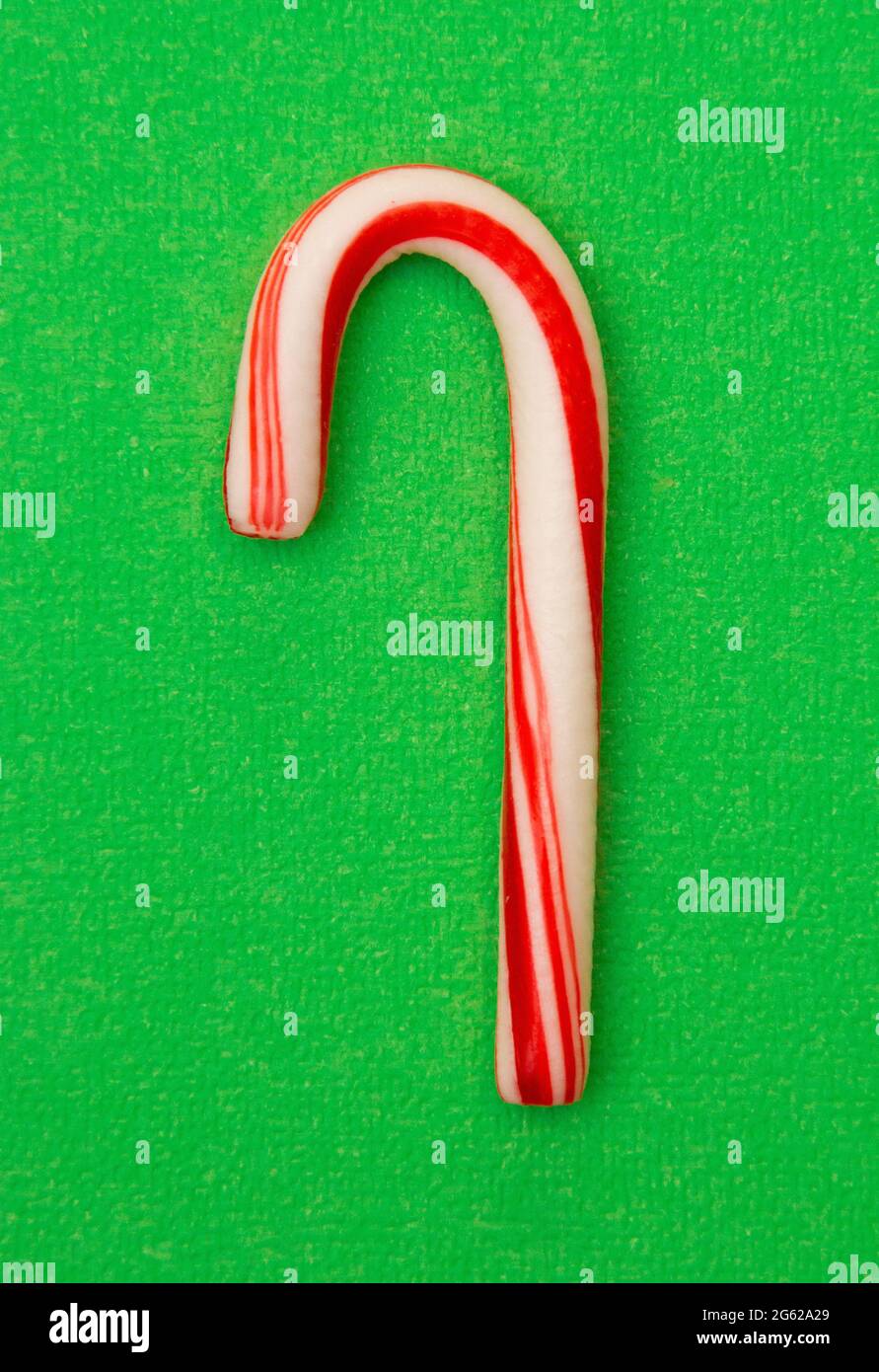 Simple Mini Candy Cane on a Green Background Stock Photo - Alamy