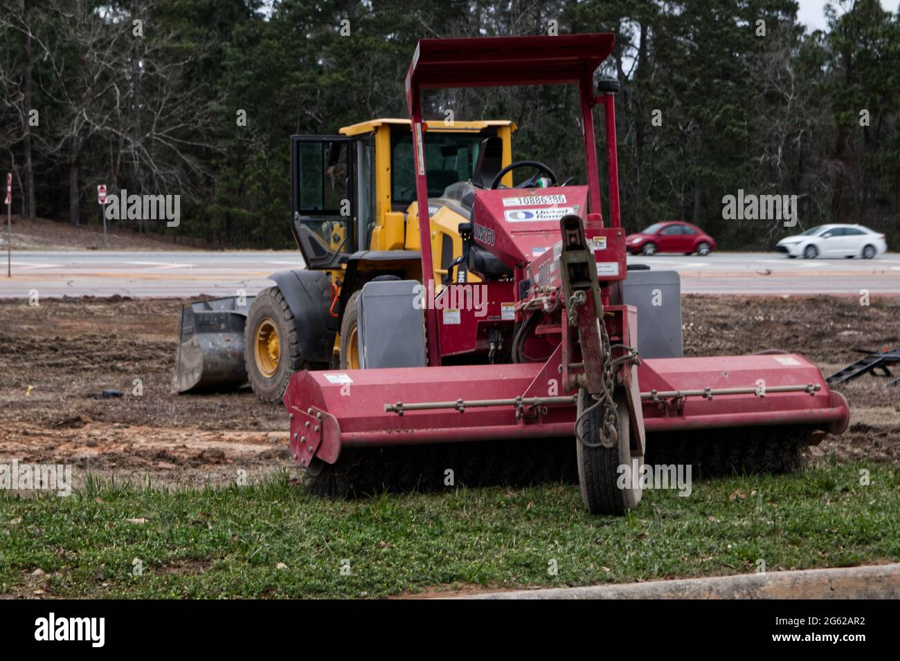 Augusta, Ga USA - 03 06 21: Yellow dozer and red street cleaner at a ...