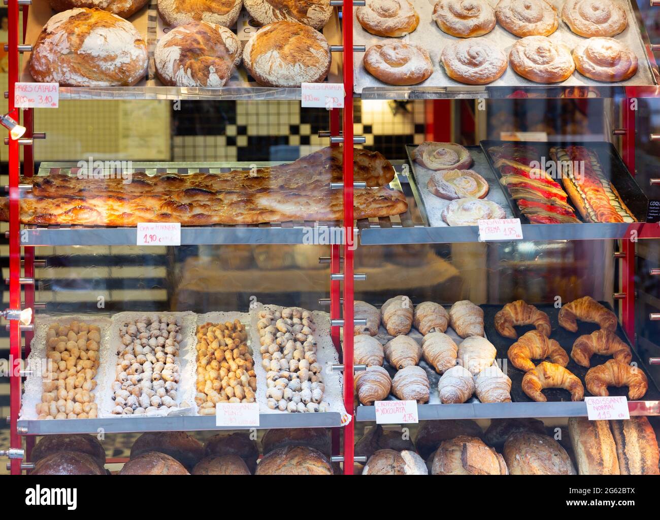 Spanish bakery showcase with price tags in Catalan Stock Photo - Alamy