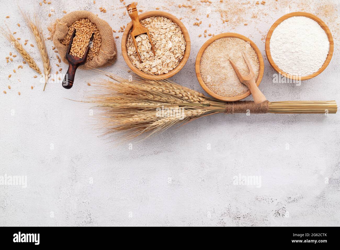 Wheat grains , brown wheat flour and white wheat flour in wooden bowl ...
