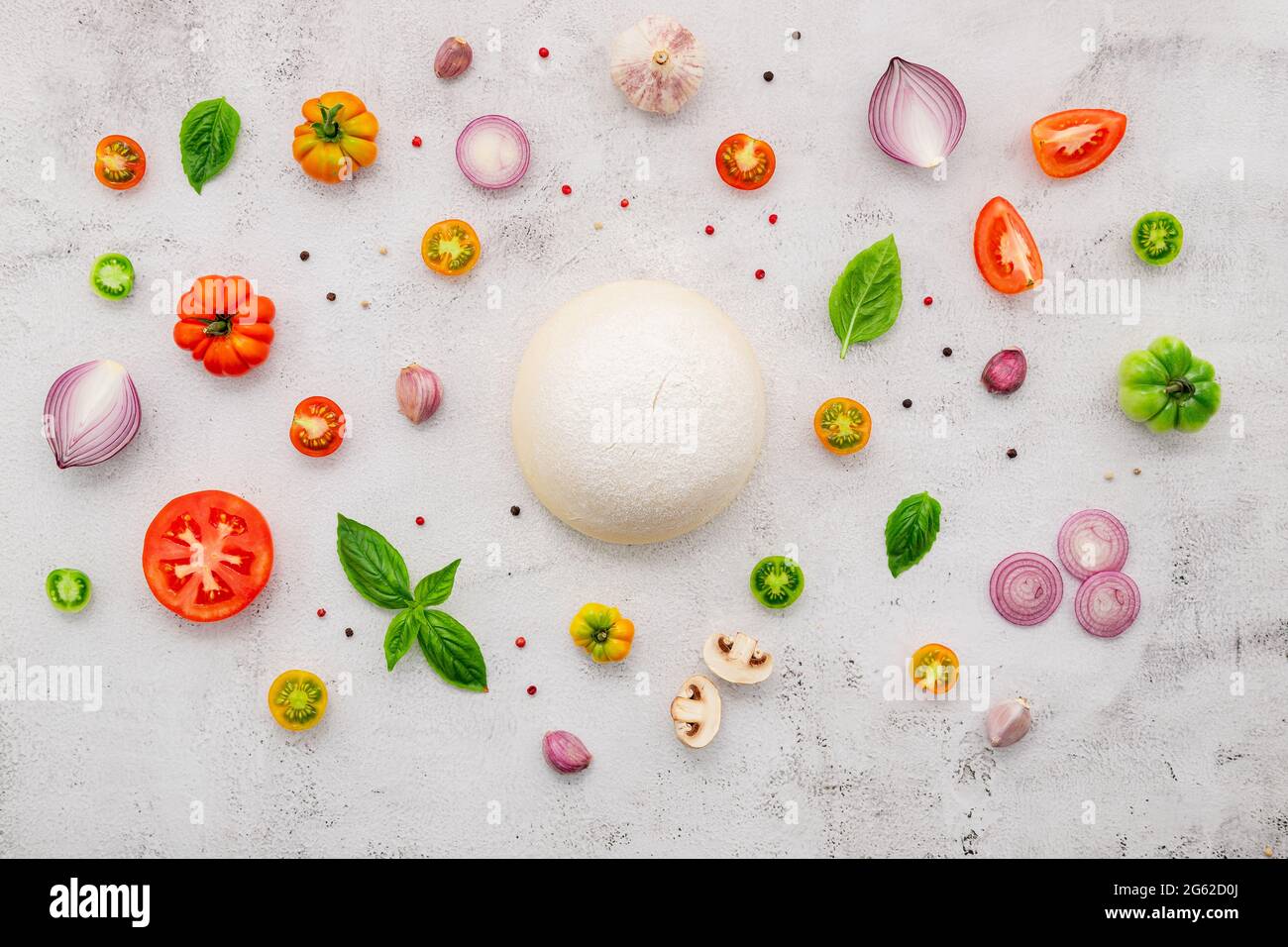 The ingredients for homemade pizza set up on white concrete background ...
