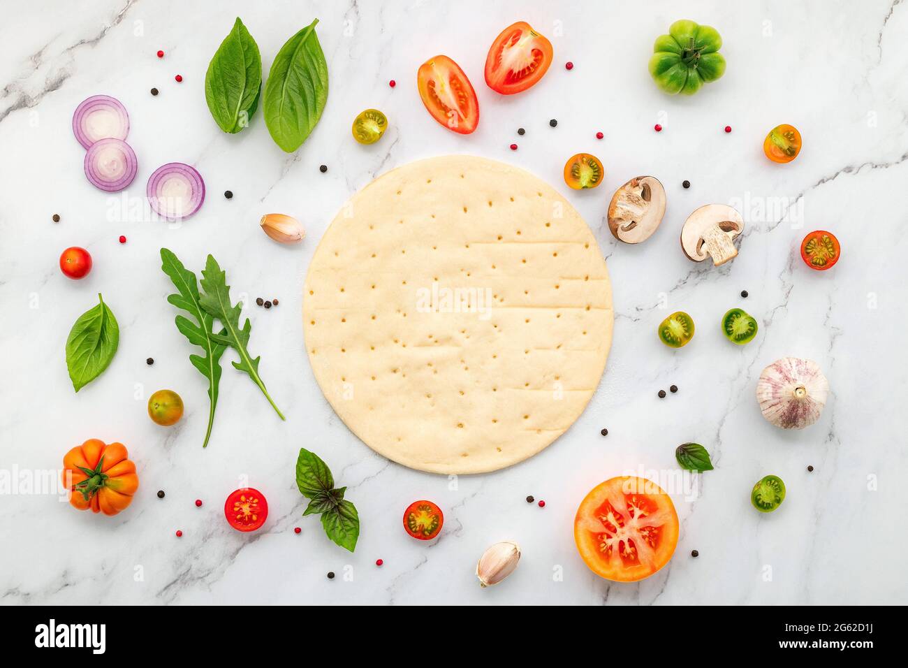 The ingredients for homemade pizza set up on white marble background ...