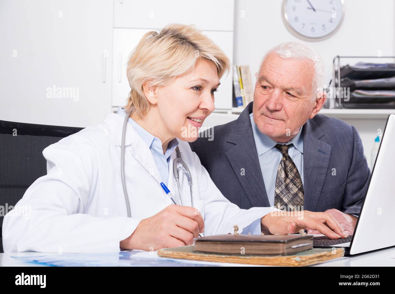 Female doctor with male client Stock Photo - Alamy