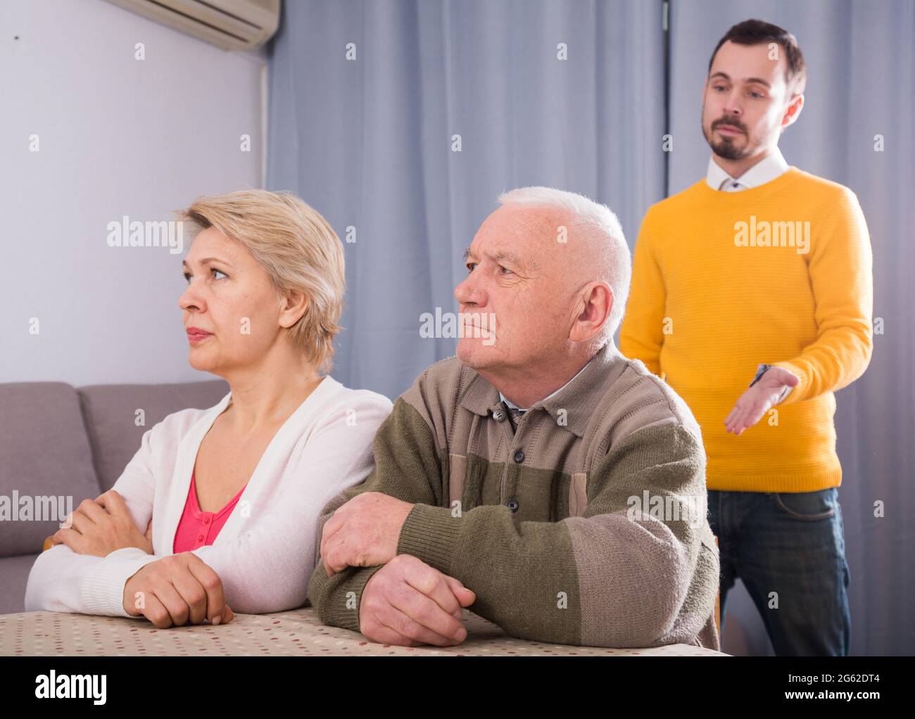 Parents arguing with son Stock Photo - Alamy