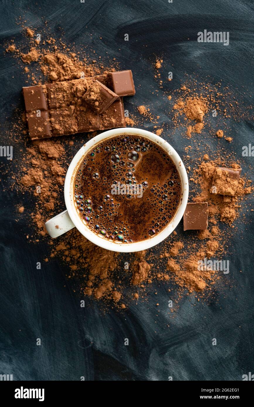 fresh hot steaming chocolate in a cup, chocolate bar and cocoa on the ...