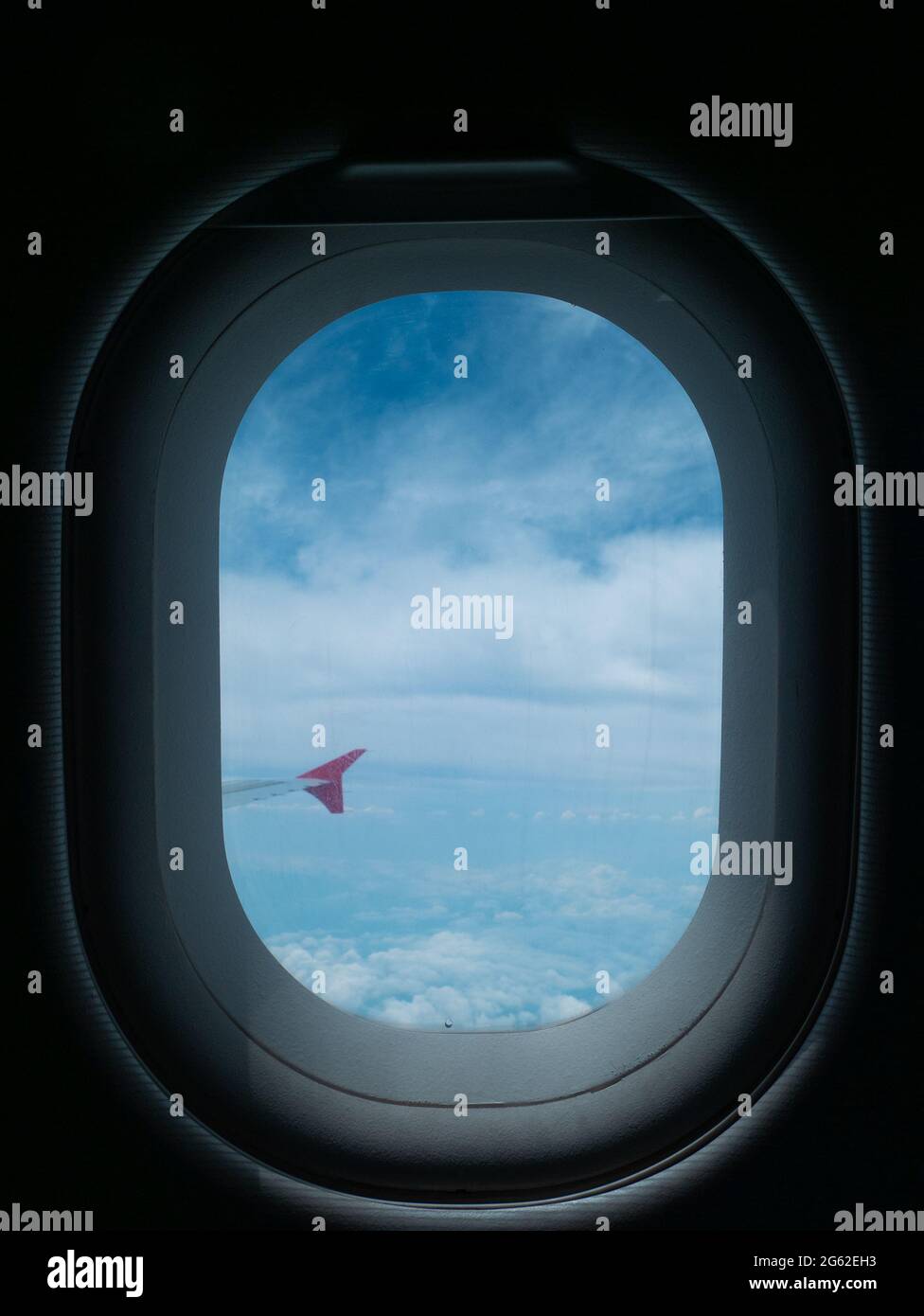 Airplane Window with View of Clouds in the Day Stock Photo - Alamy