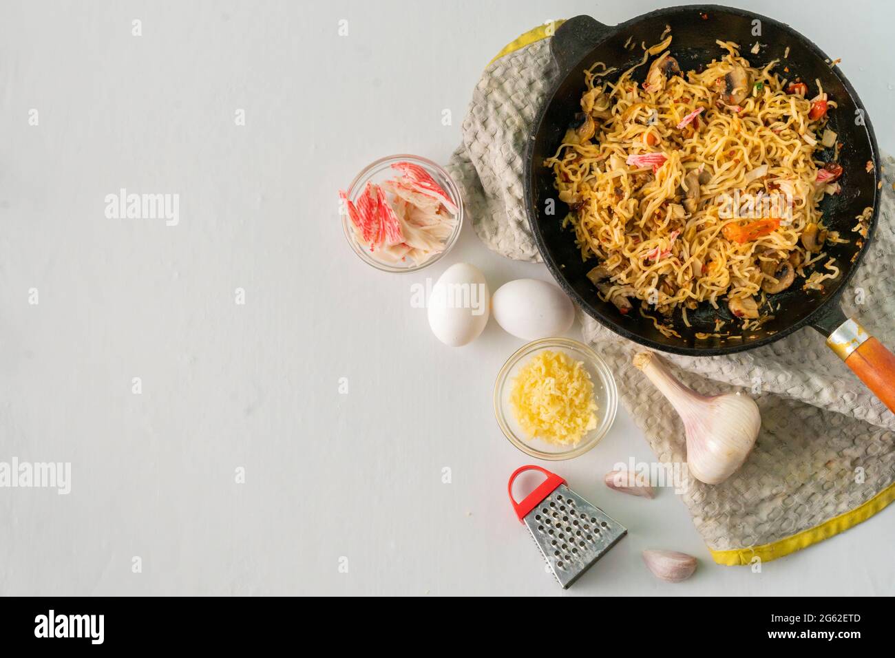 hot carbonaro paste in a pan with spices and ingredients on the table ...