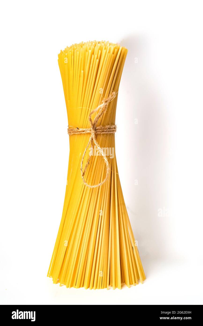 roped or tied bunch od dry uncooked spaghetti isolated on white surface ...