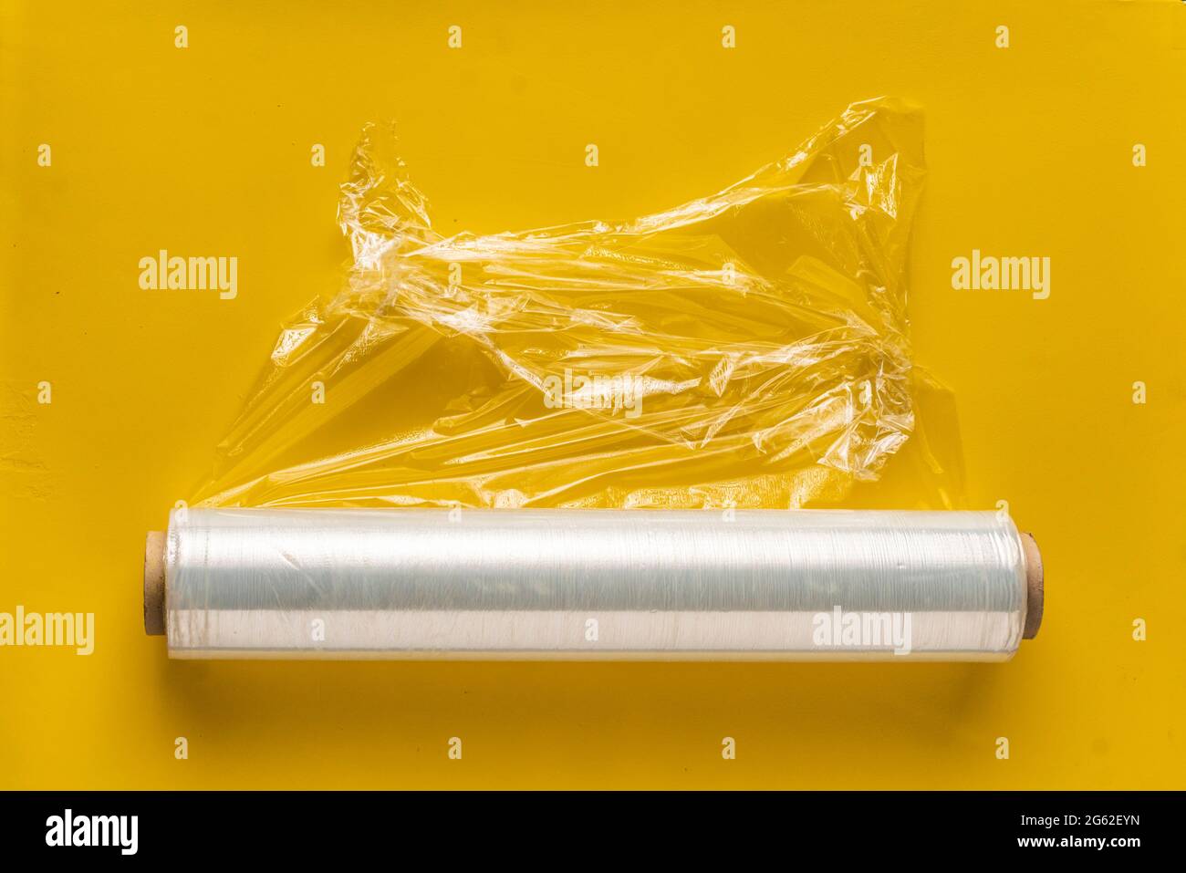 roll of wrapping stretch film for packing at colorful background ...