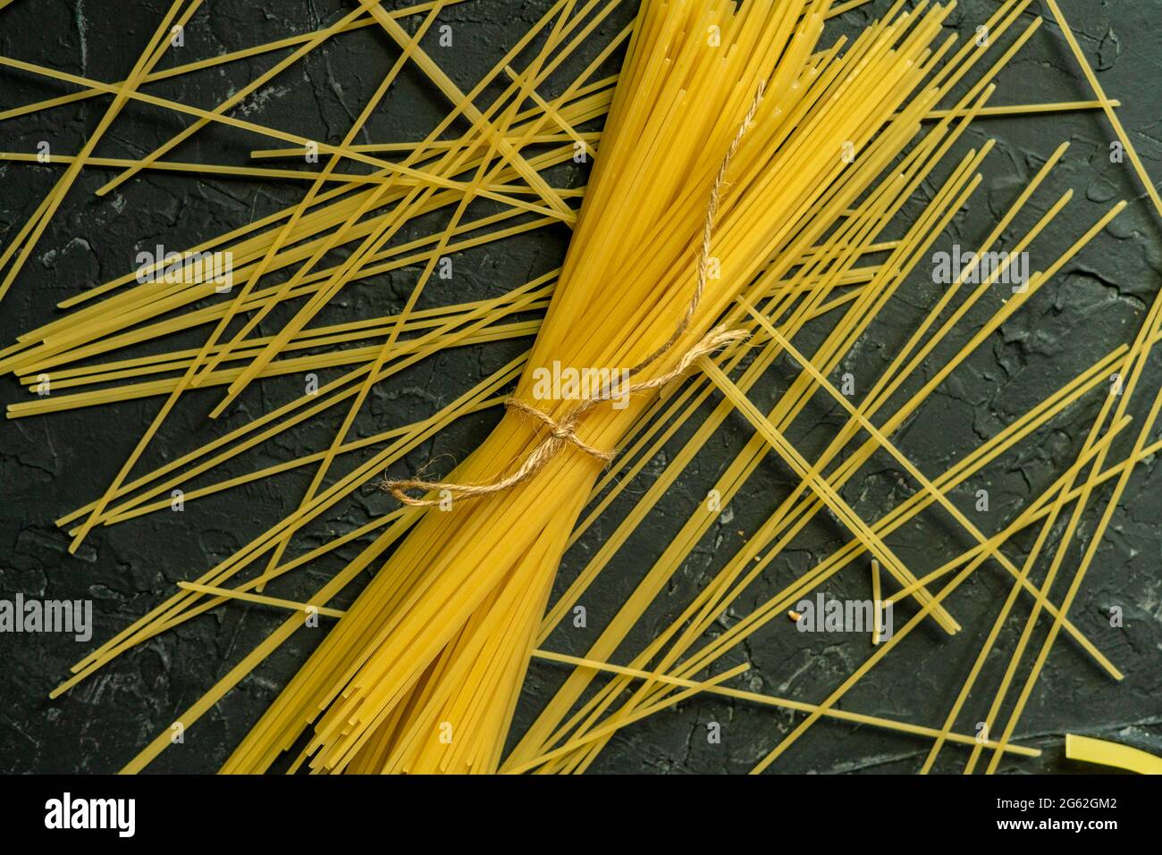 bunch of raw spaghetti top view, flat lay on dark surface Stock Photo ...