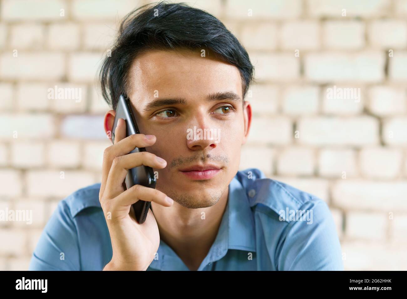 The guy is talking on the phone, close-up. Caucasian young brunette man ...