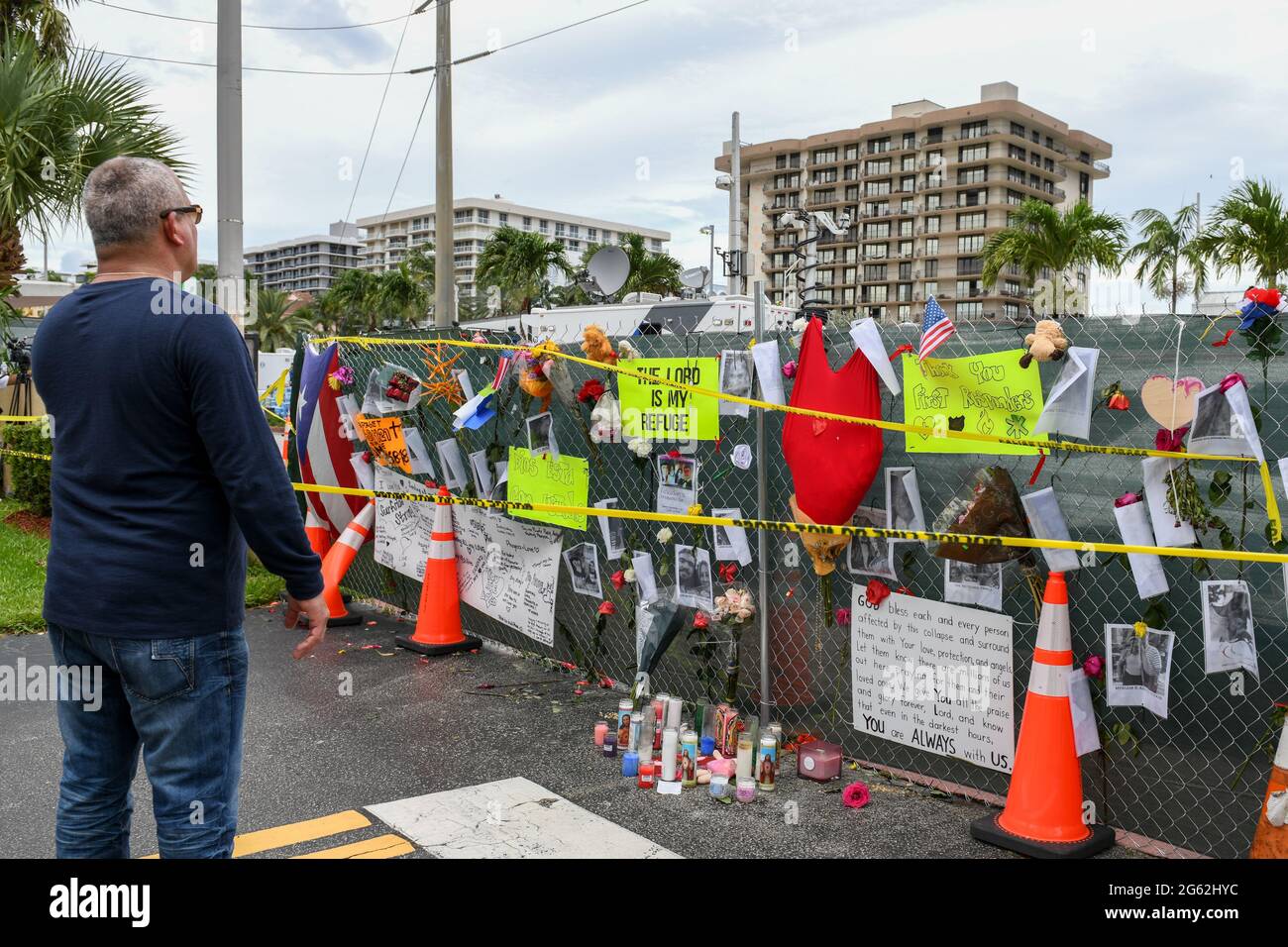 SURFSIDE, FL July 1 2021 A man stands at the memorial. It has pictures ...