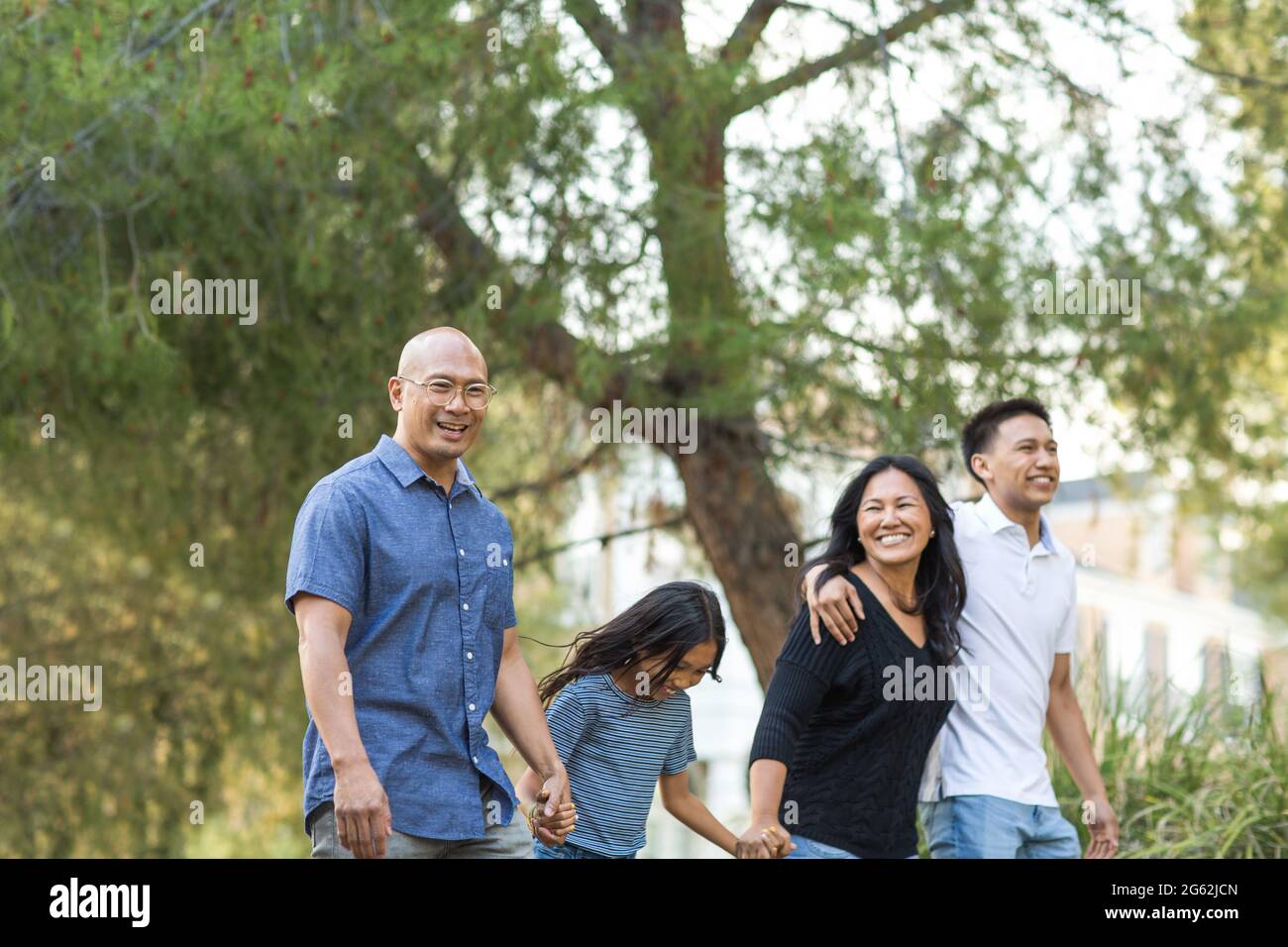 Happy Asian family walking and talking outside Stock Photo - Alamy