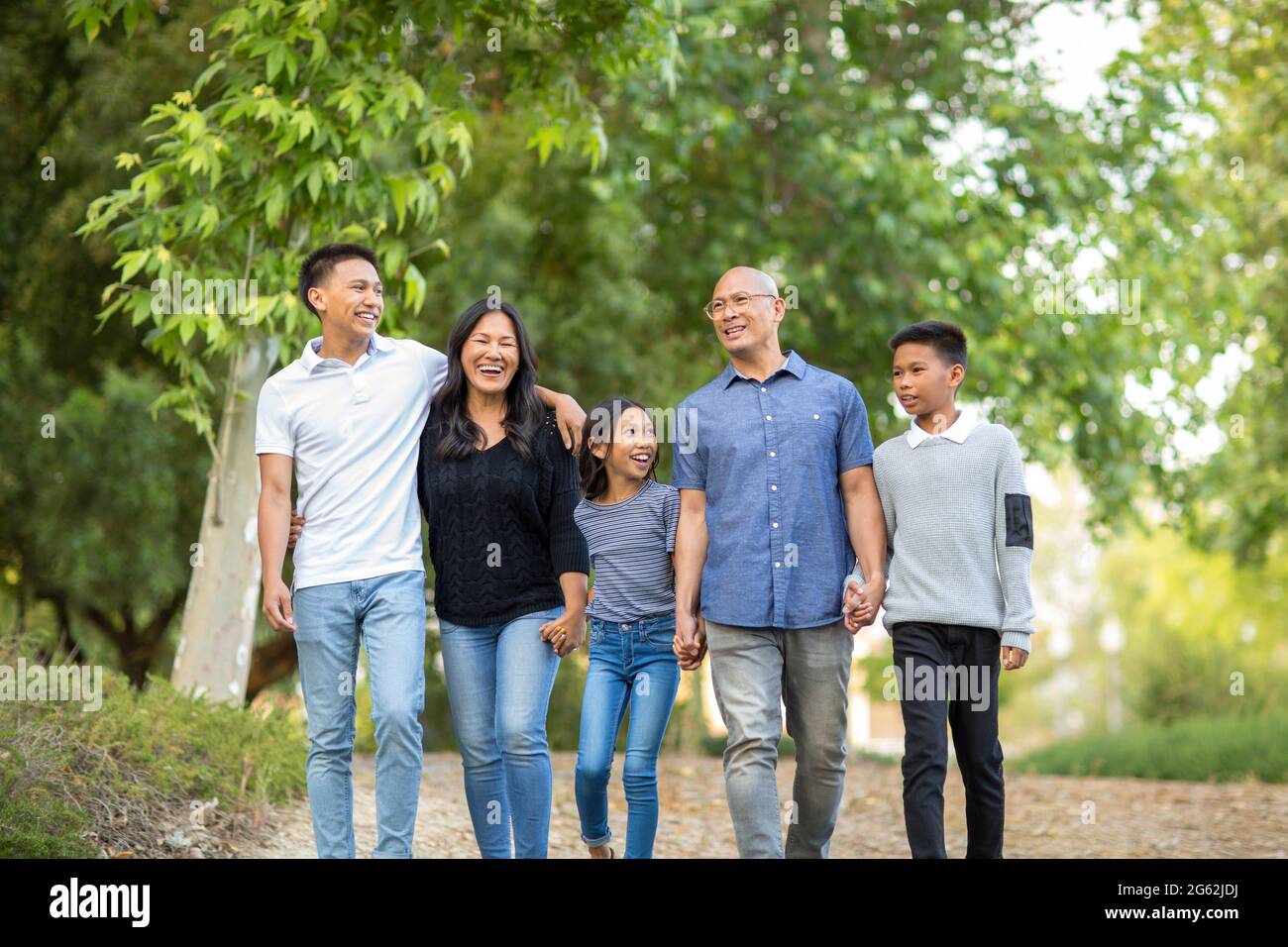 Happy Asian family walking and talking outside Stock Photo - Alamy