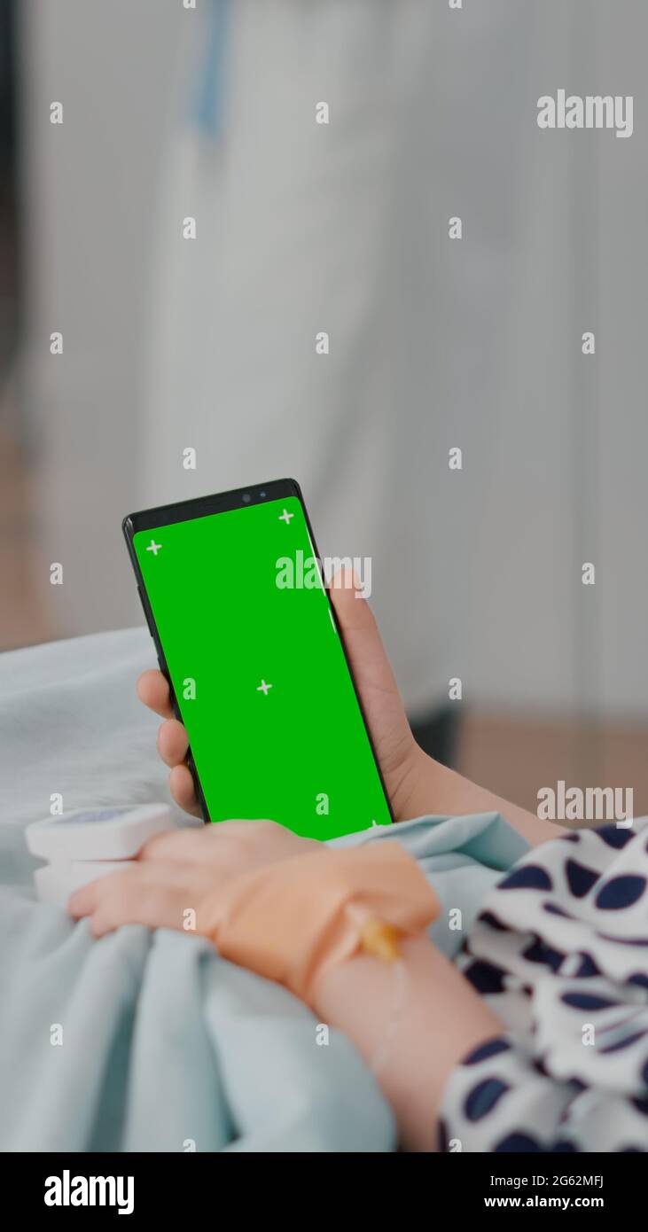 Little kid holding mock up green screen chroma key phone with isolated ...