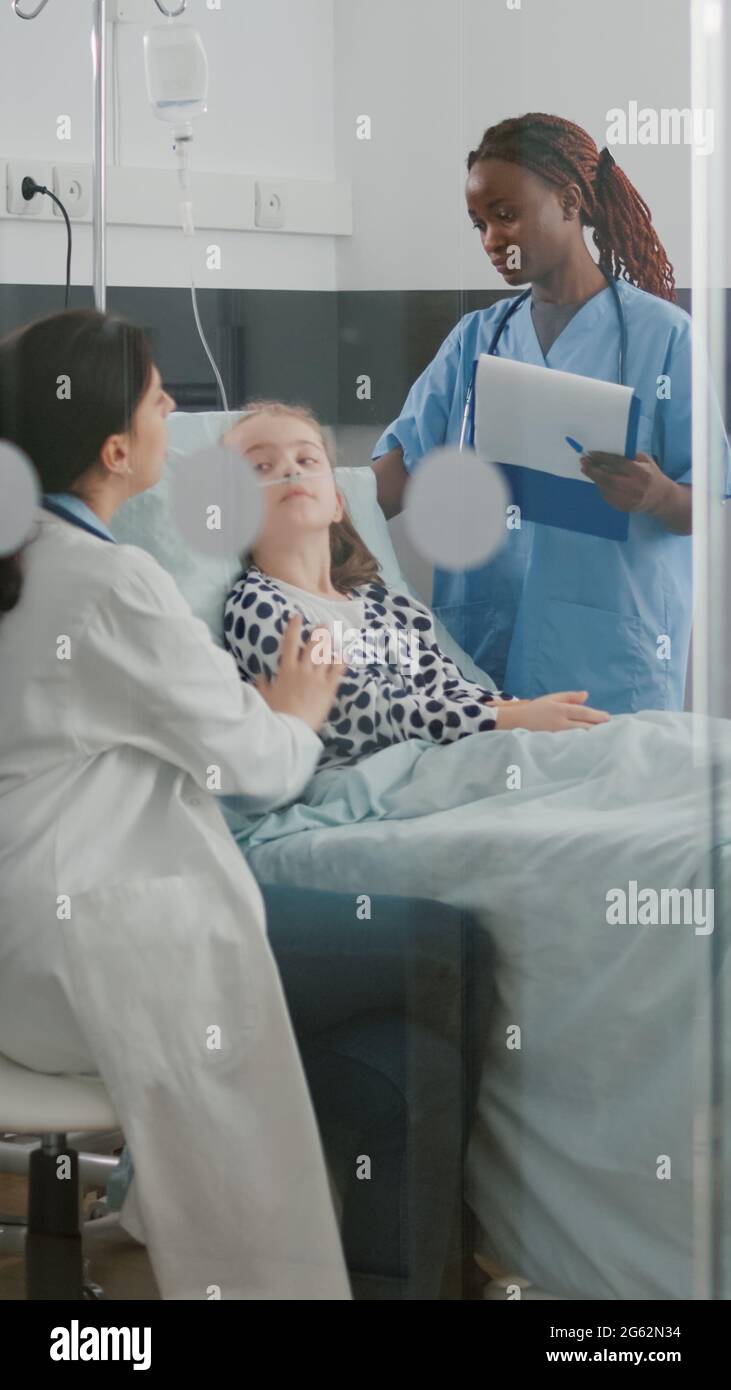 Pediatric doctor examining breathing sickness symptoms while african ...