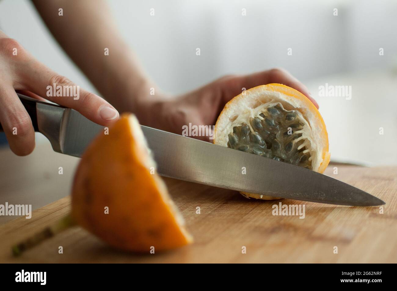 Fresh organic ripe granadilla or yellow passion fruit cut in half on a ...
